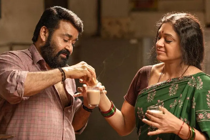 Poster of 'Thudarum' featuring Mohanlal and Shobana bonding over tea ...