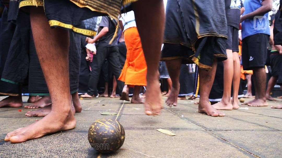 Rolling coconuts and sprinkling turmeric powder at Malikappuram not ...