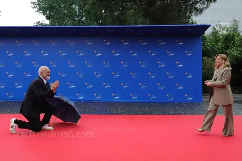 Albanian PM Edi Rama kneels with 'namaste' to welcome Italian PM Meloni ...